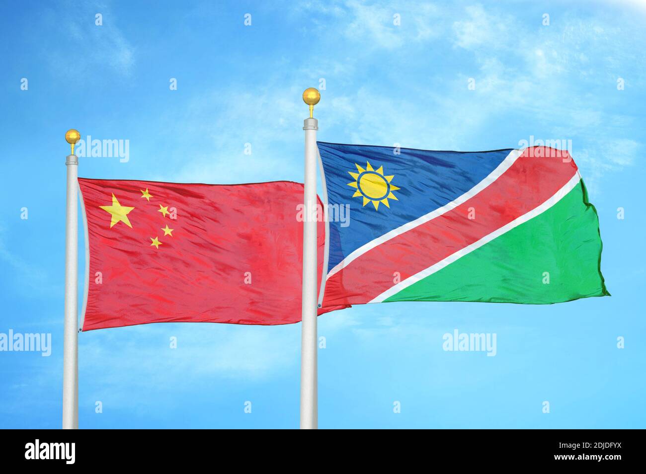 China and Namibia two flags on flagpoles and blue cloudy sky Stock ...