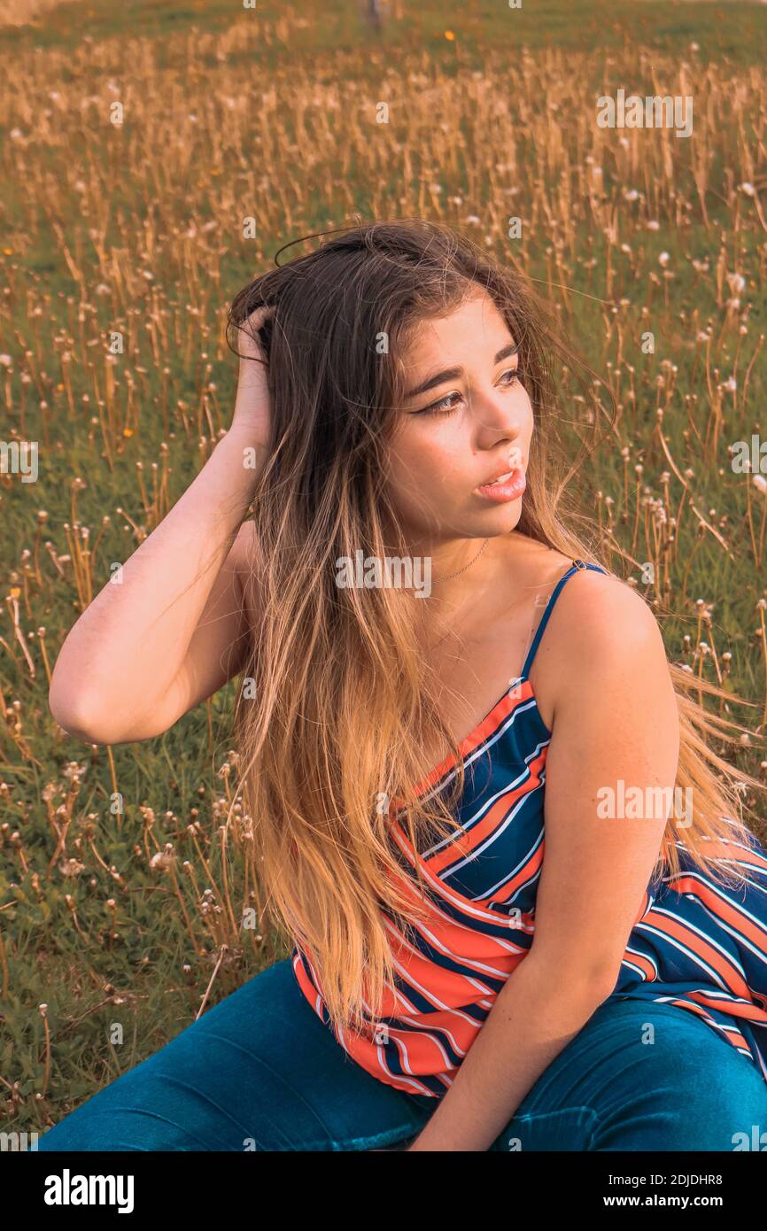 Beauty blond model sitting down hi-res stock photography and images - Alamy