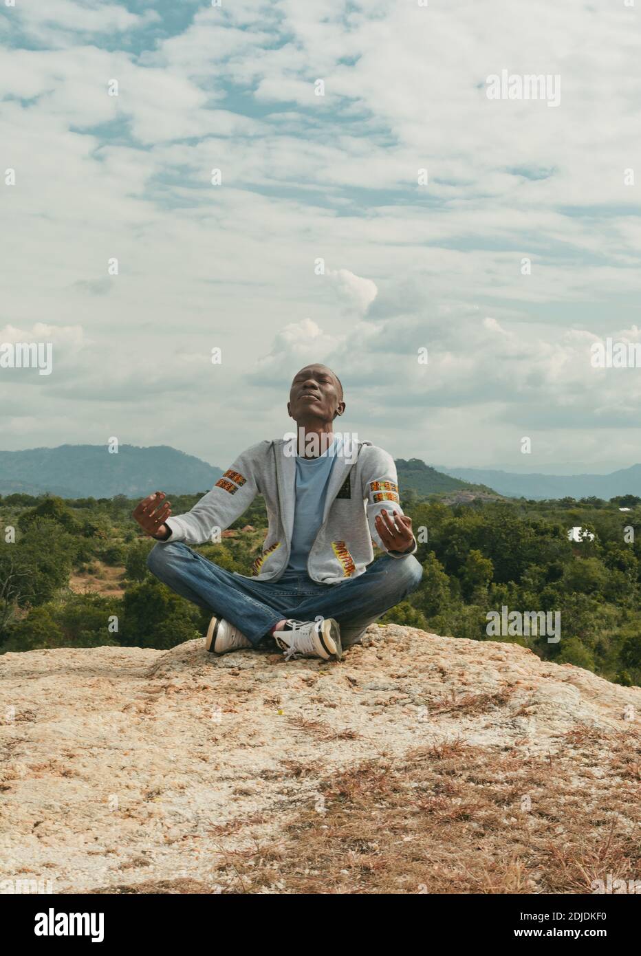 Man meditating on top mountain hi-res stock photography and images - Alamy