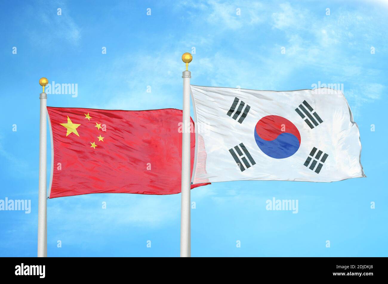 China and South Korea two flags on flagpoles and blue cloudy sky Stock ...