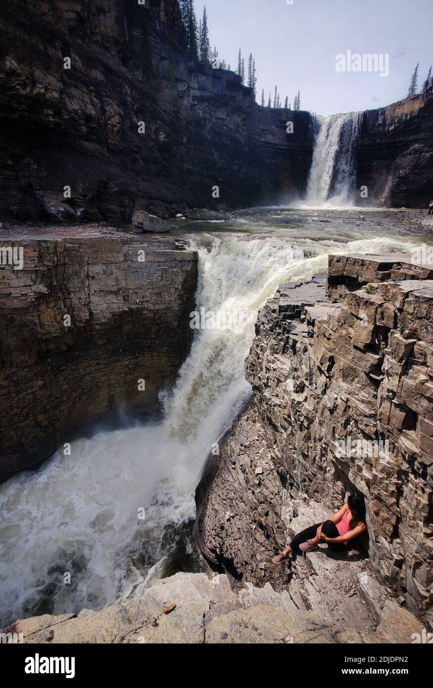Person sitting beside a waterfall hi-res stock photography and images ...