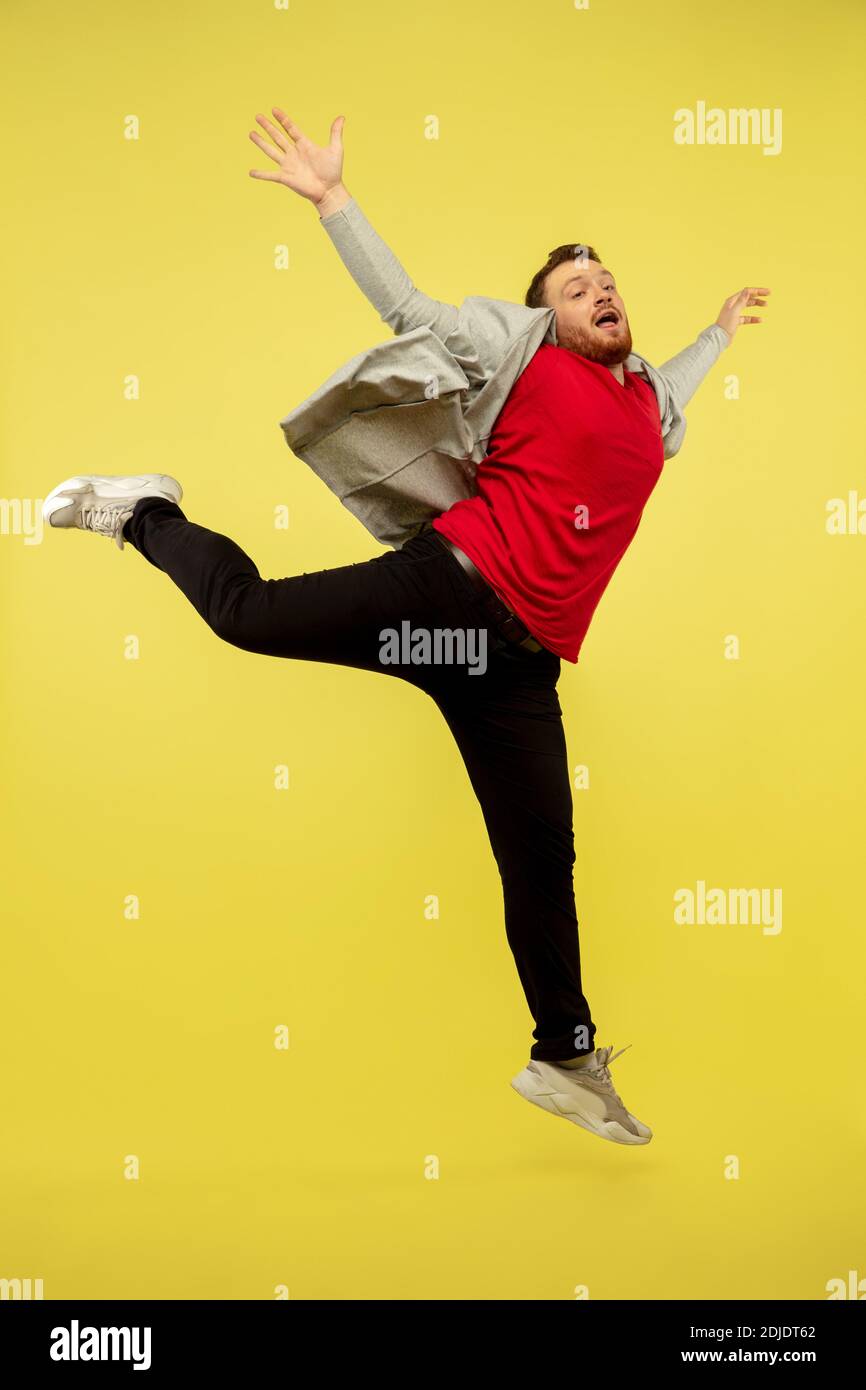 Happiness. Full length portrait of young high jumping man gesturing ...