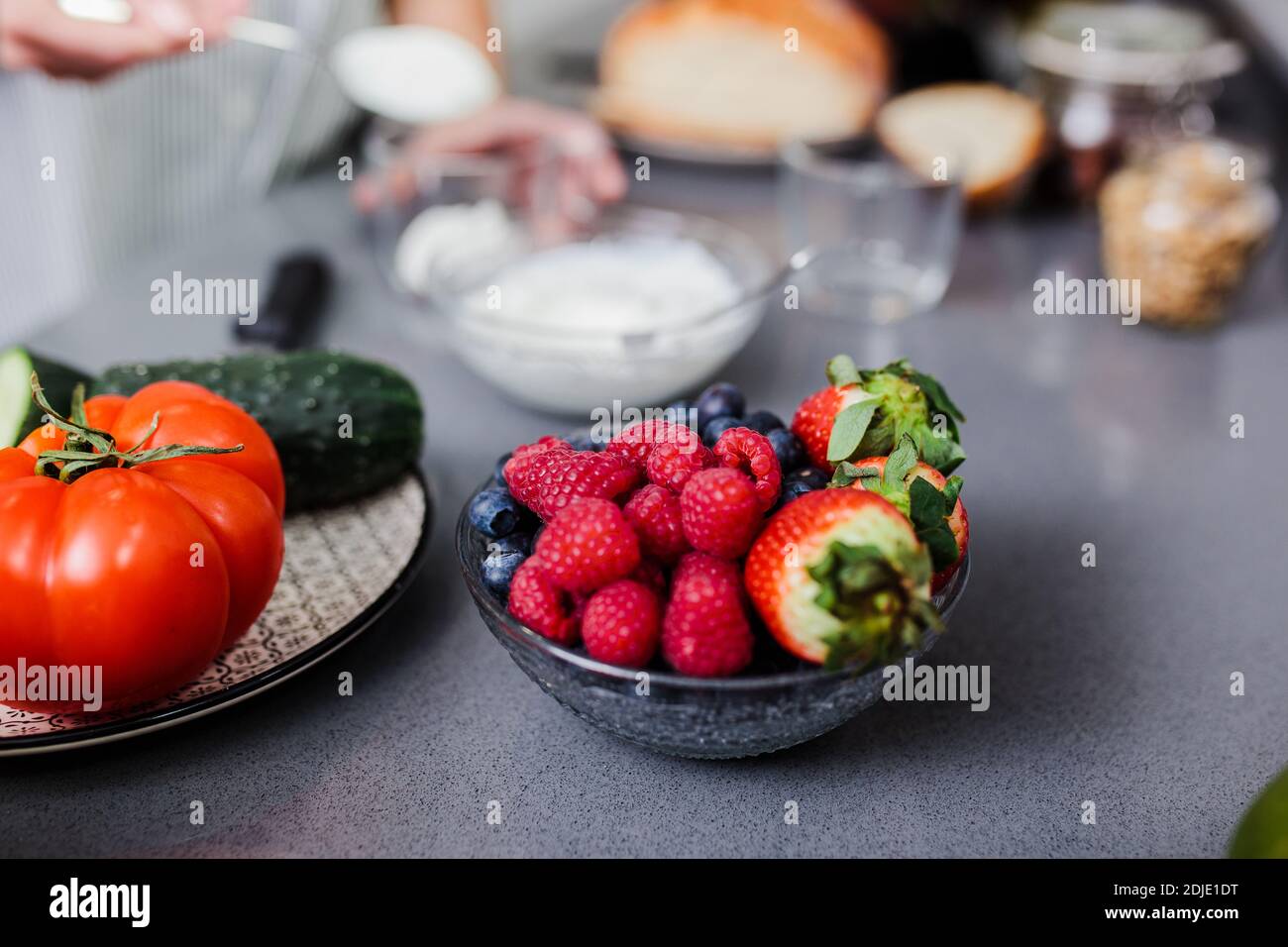 Women preparing healthy food playing with vegetables in kitchen having ...
