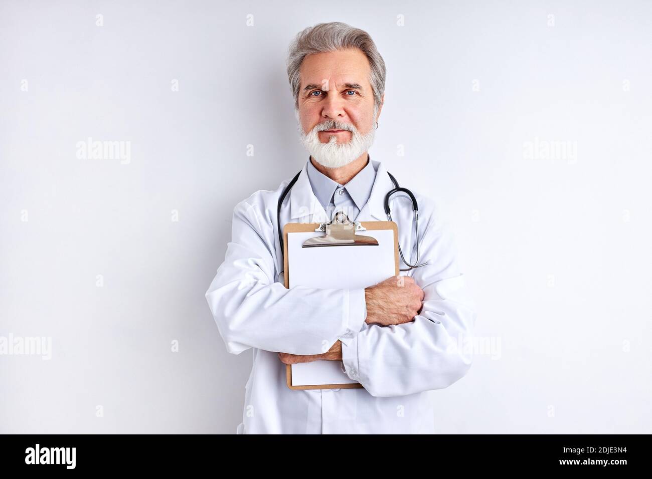 kind mature doctor man with tablet paper in hands, posing at camera ...