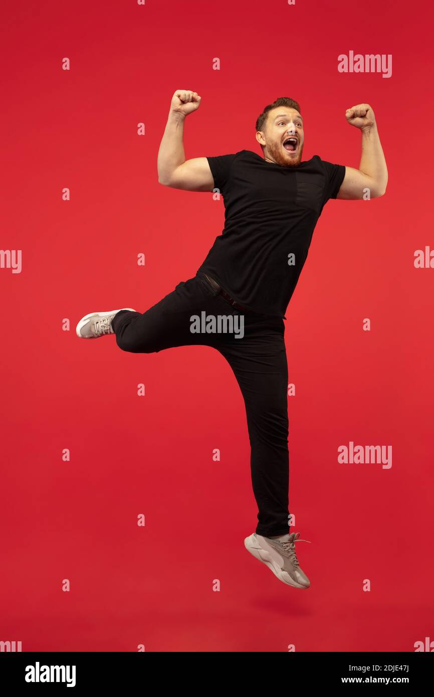Winner. Full length portrait of young successfull high jumping man ...