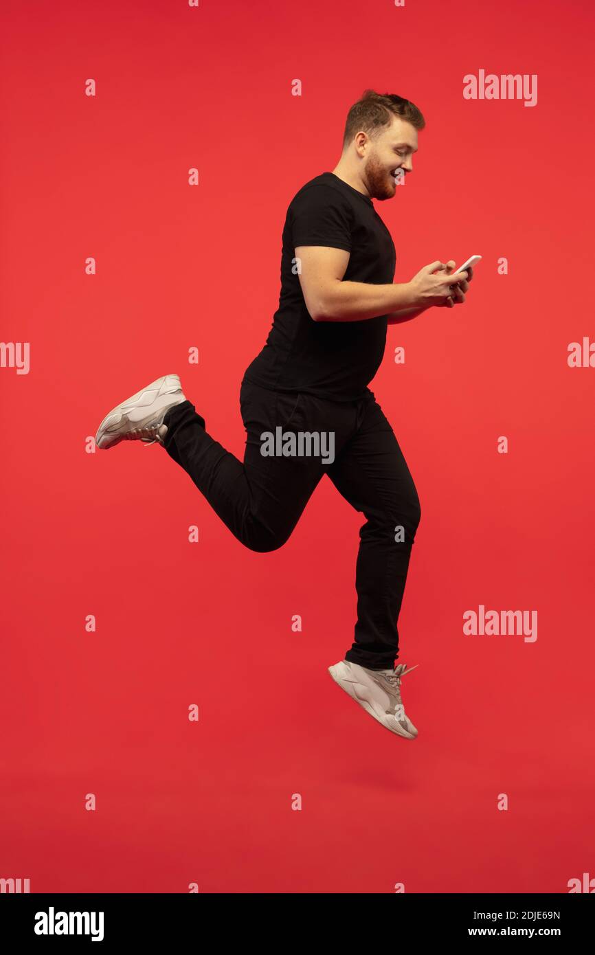 Chatting. Full length portrait of young successfull high jumping man ...