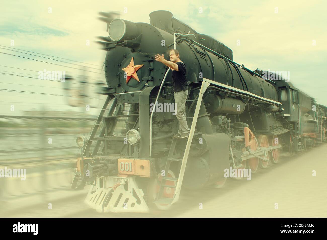 A man stands on a vintage locomotive. The old train of the revolution ...