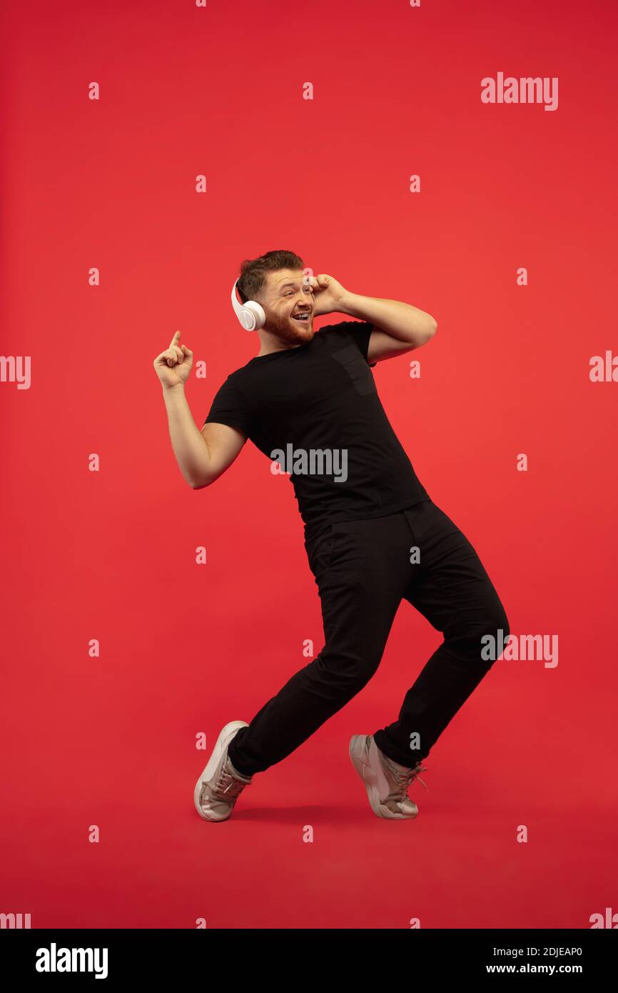 Dancing expressive. Full length portrait of young high jumping man ...