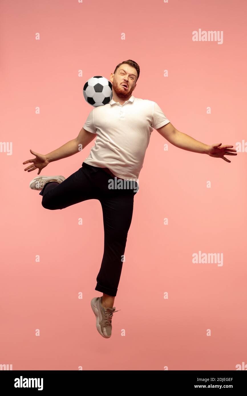Catching ball with face football fan. Full length portrait of young ...