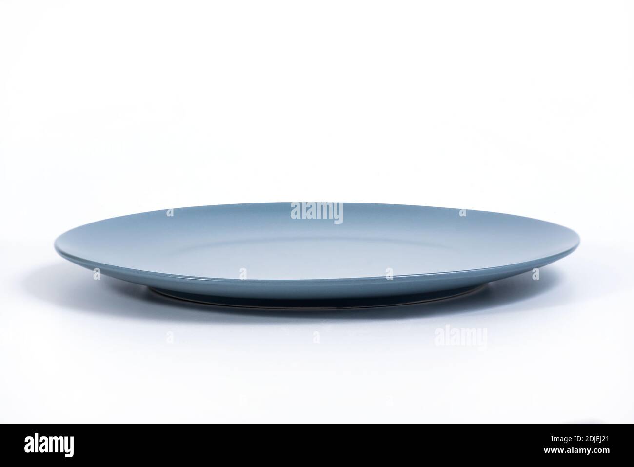 Large Empty Navy Blue plate isolated on white background side view ...