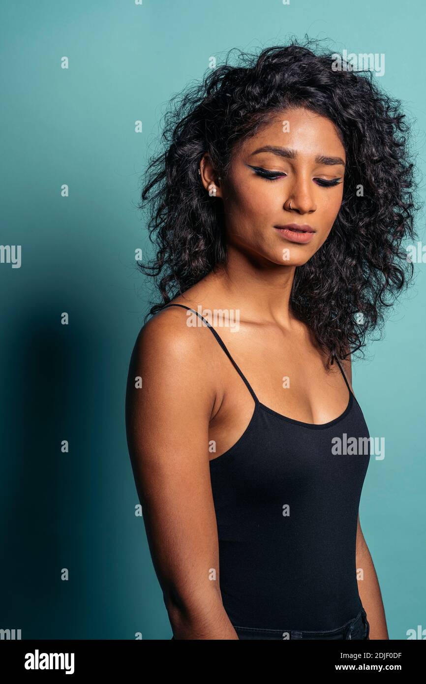 Stock photo of beautiful young woman wearing cool make up looking down ...