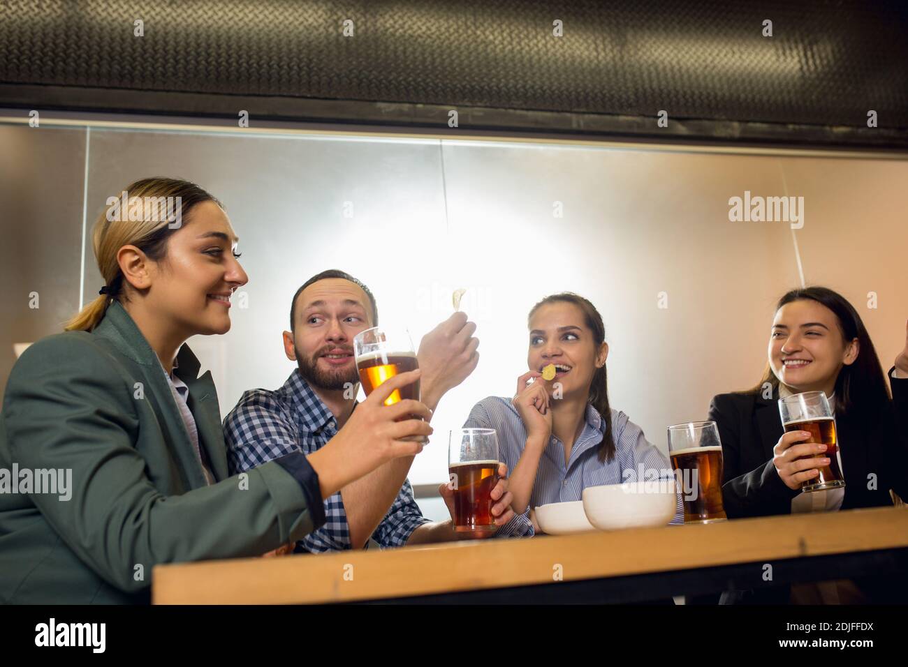 Laughting. Happy co-workers celebrating corporate event after tensioned ...