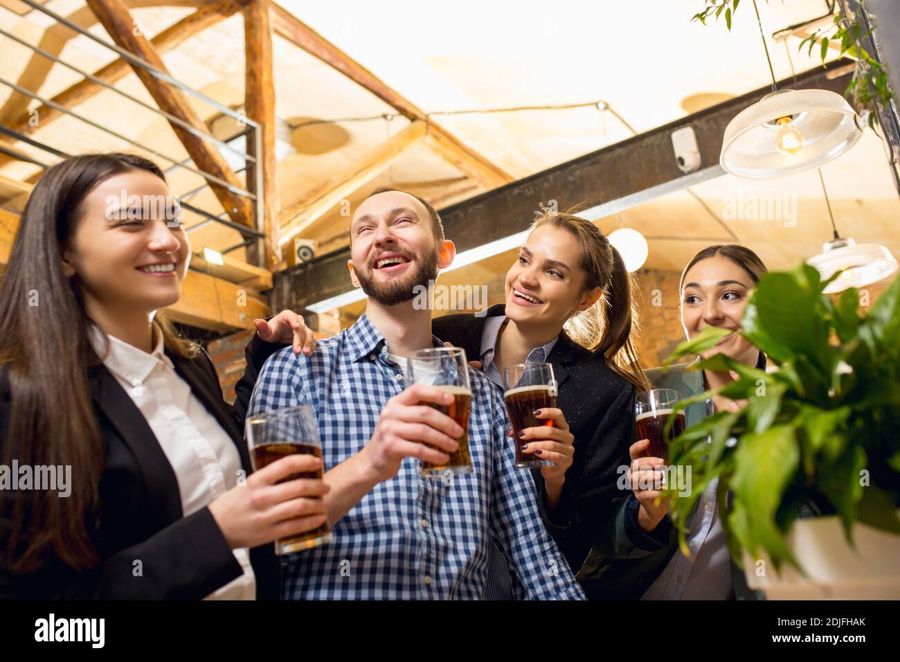 Having fun. Happy co-workers celebrating corporate event after ...