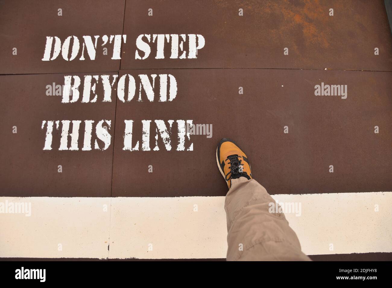 Low Section Of Person With Text On Floor Stock Photo - Alamy