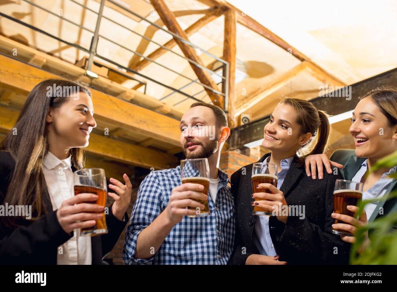 Having fun. Happy co-workers celebrating corporate event after ...