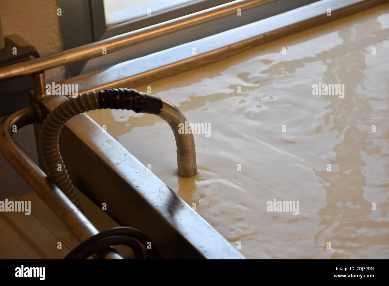 Detail of mechanism in tank full of milk Stock Photo - Alamy