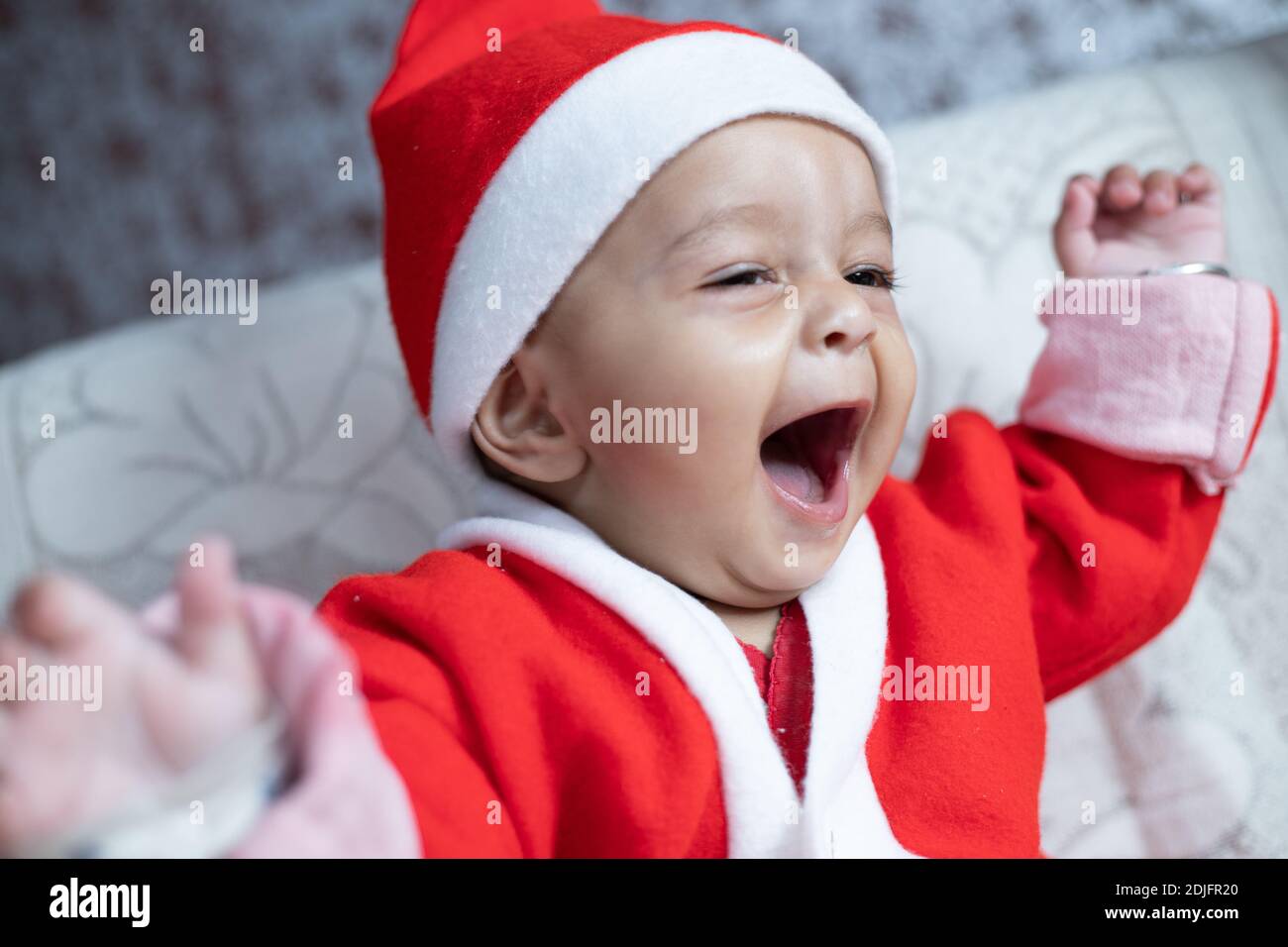 Portrait of Baby smiling in Santa costume Stock Photo - Alamy