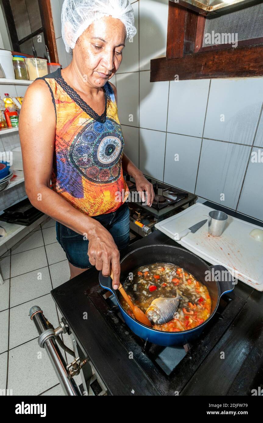 A cook cooks a yellow-belly piranha for a soup. The piranha soup is ...