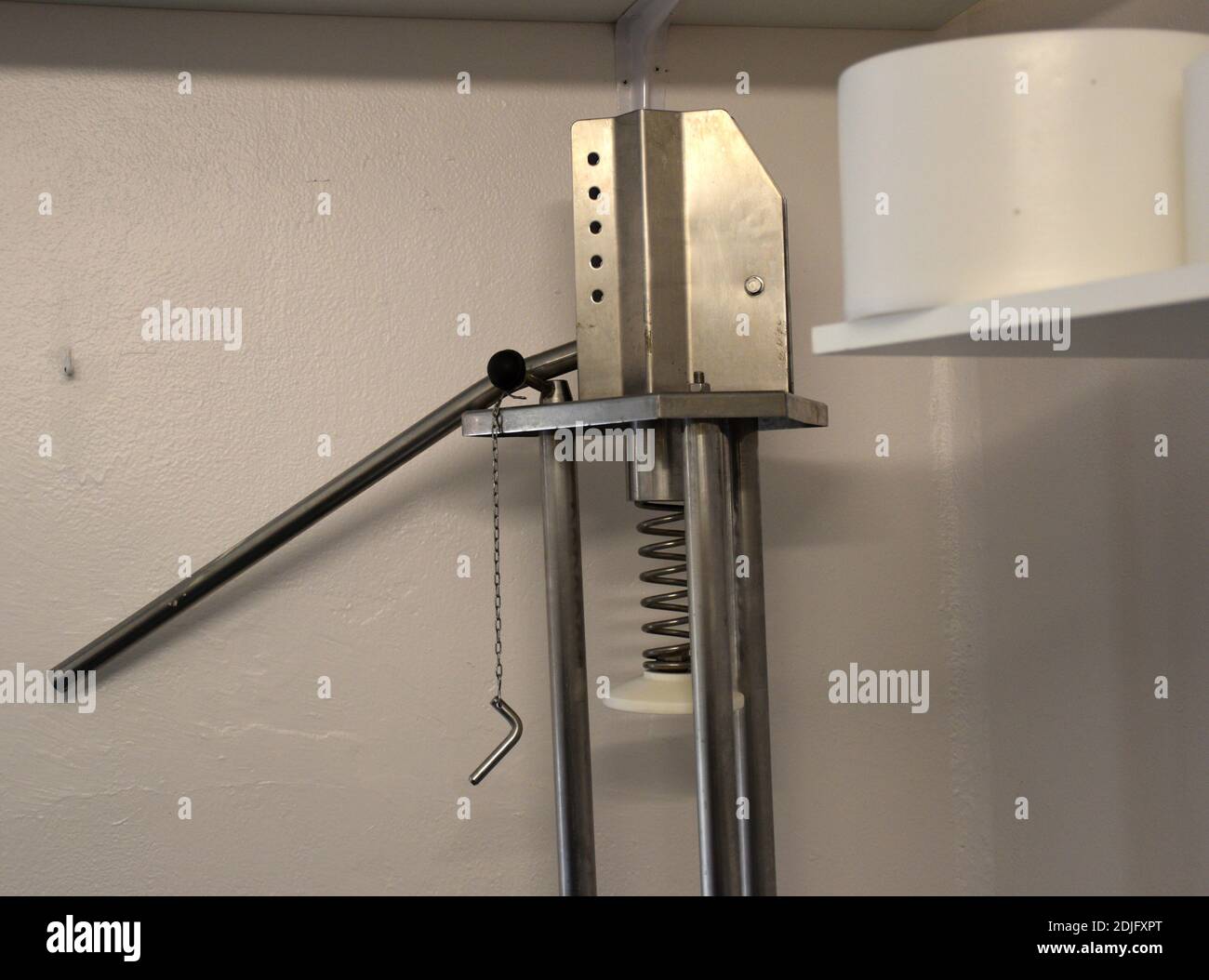 Manual press in artisan cheese factory. Cheese making Stock Photo - Alamy