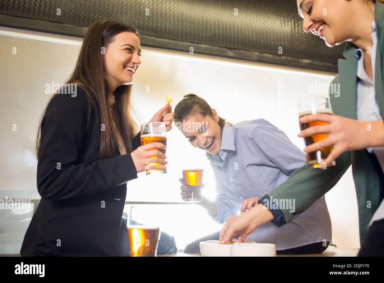 Unity. Happy co-workers celebrating corporate event after tensioned ...