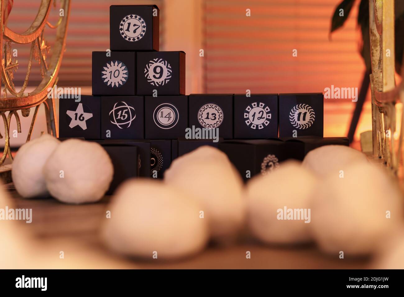 A Christmas calendar made out of black cubes in back of white white ...