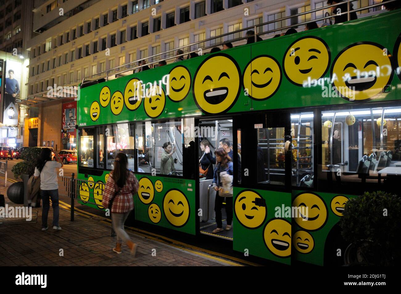 A Hong Kong bus with smiley faces in Kowloon shopping district. Ernie ...