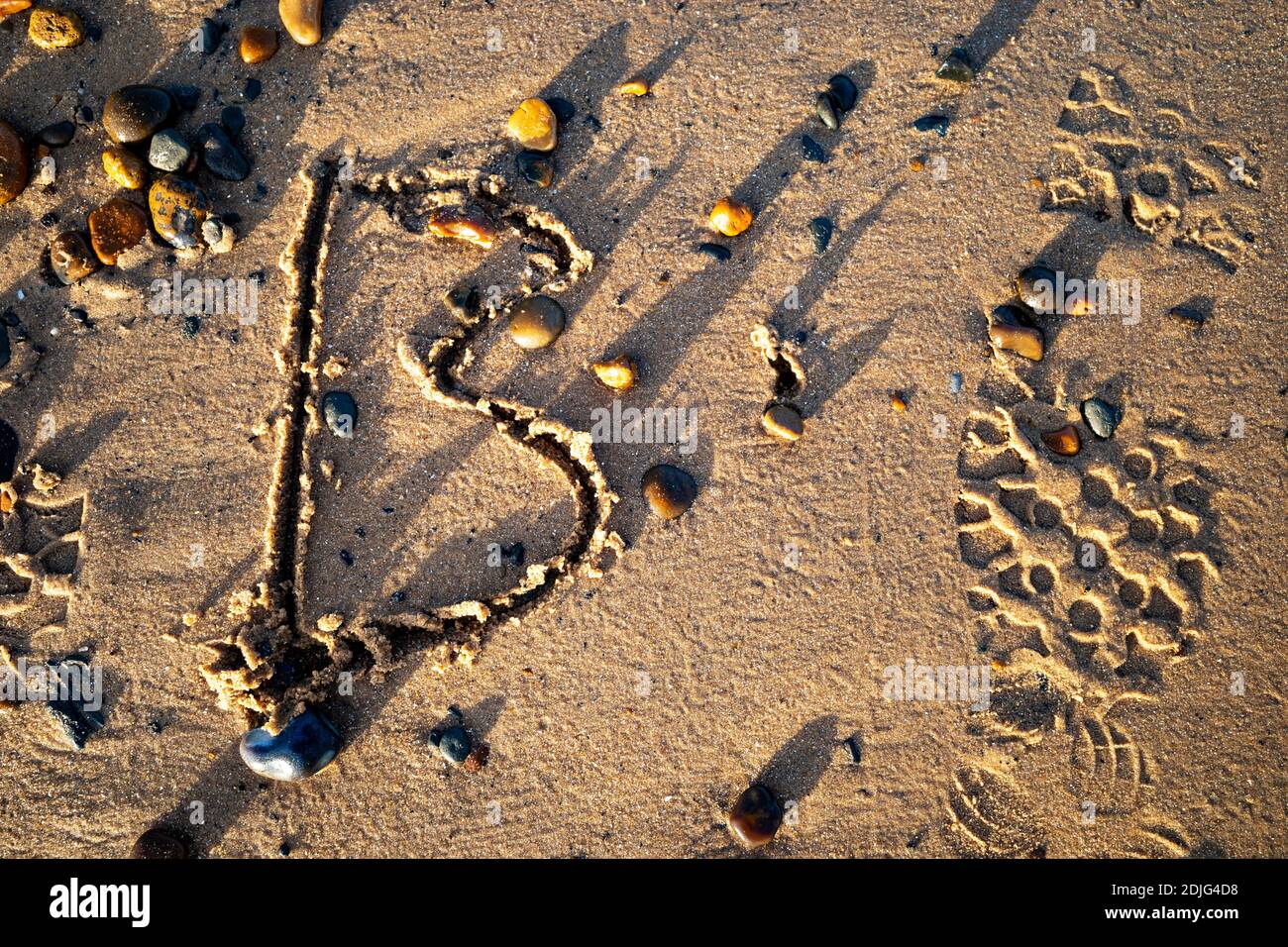 Letter B and footprint in the sand Stock Photo - Alamy