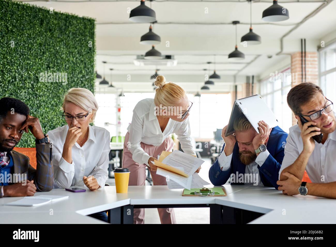 team of sad frustrated employees receiving rebuke by shouting female ...