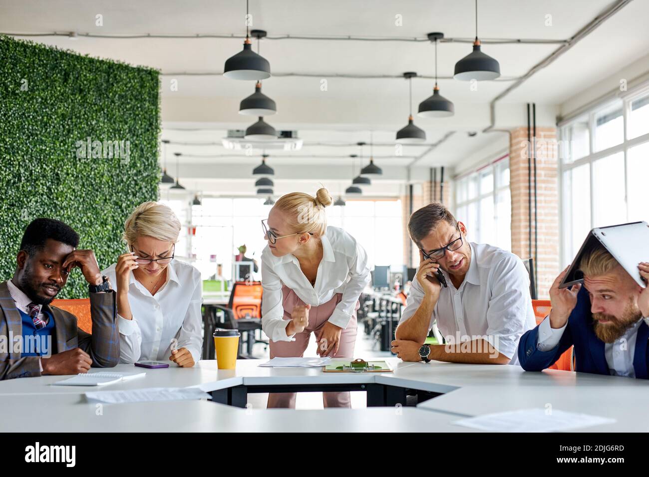 team of sad frustrated employees receiving rebuke by shouting female ...