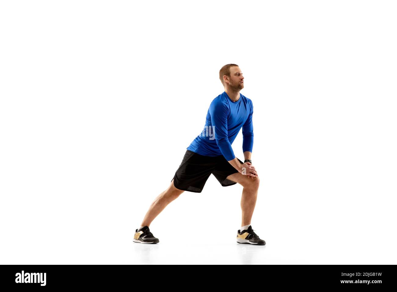 Prepares. Caucasian professional jogger, runner training isolated on ...