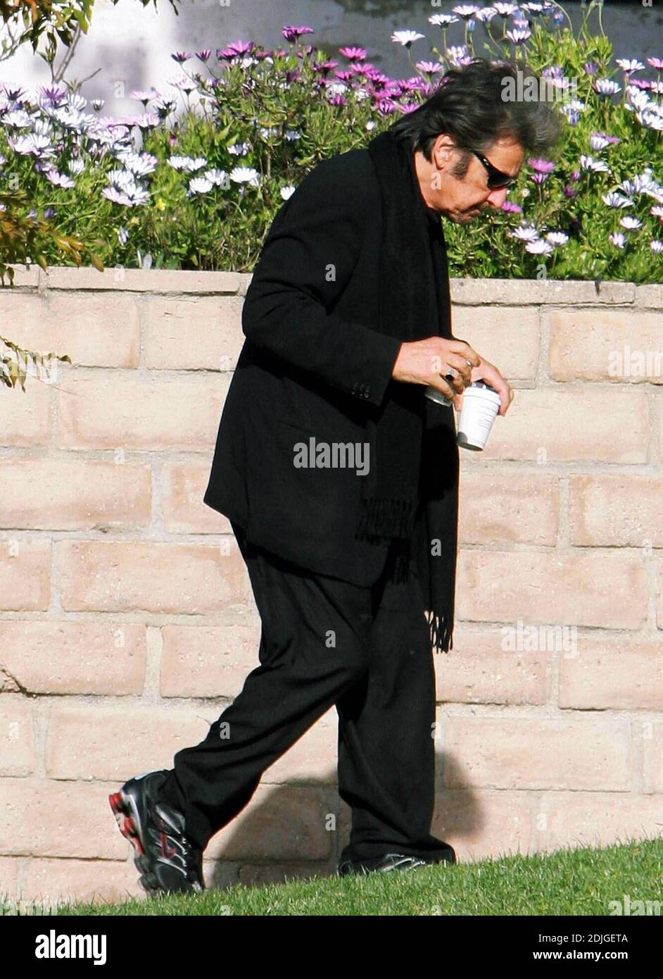Al Pacino, wearing his trade mark black, takes two cups of coffe for a ...