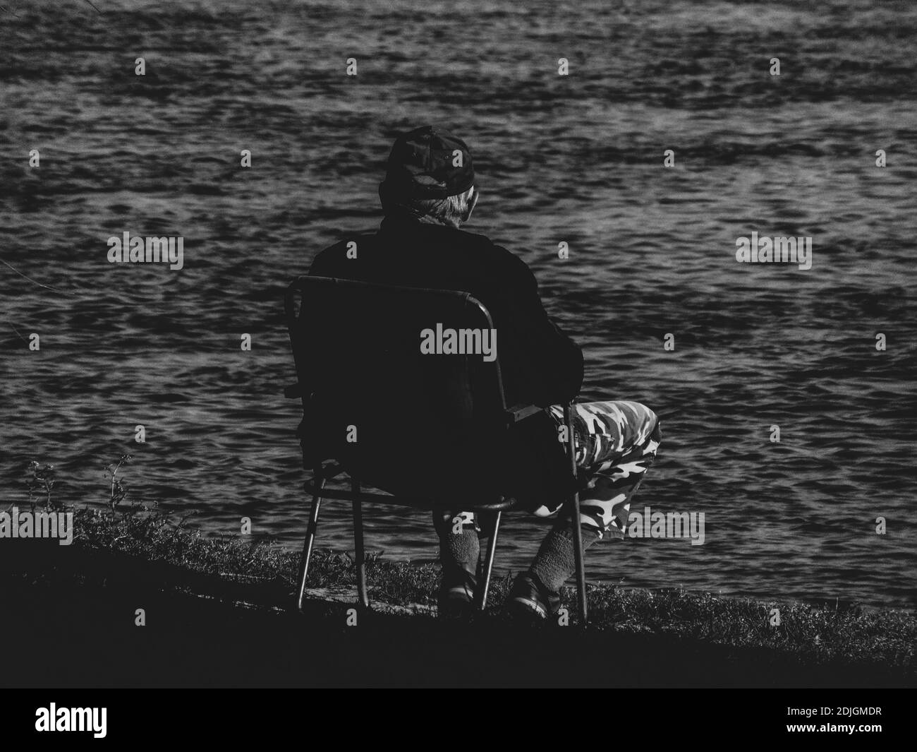 Man sitting on chair, rear Black and White Stock Photos & Images - Alamy
