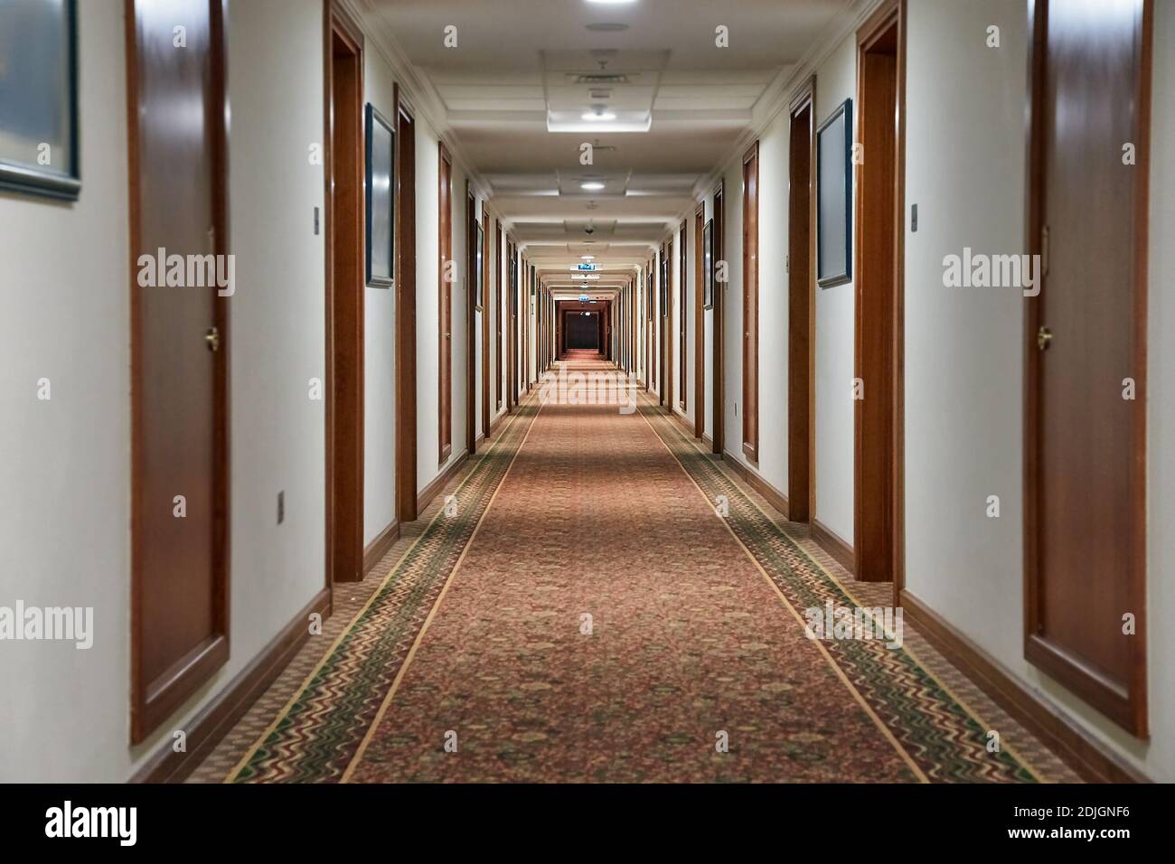Corridor with with long line of doors Stock Photo - Alamy
