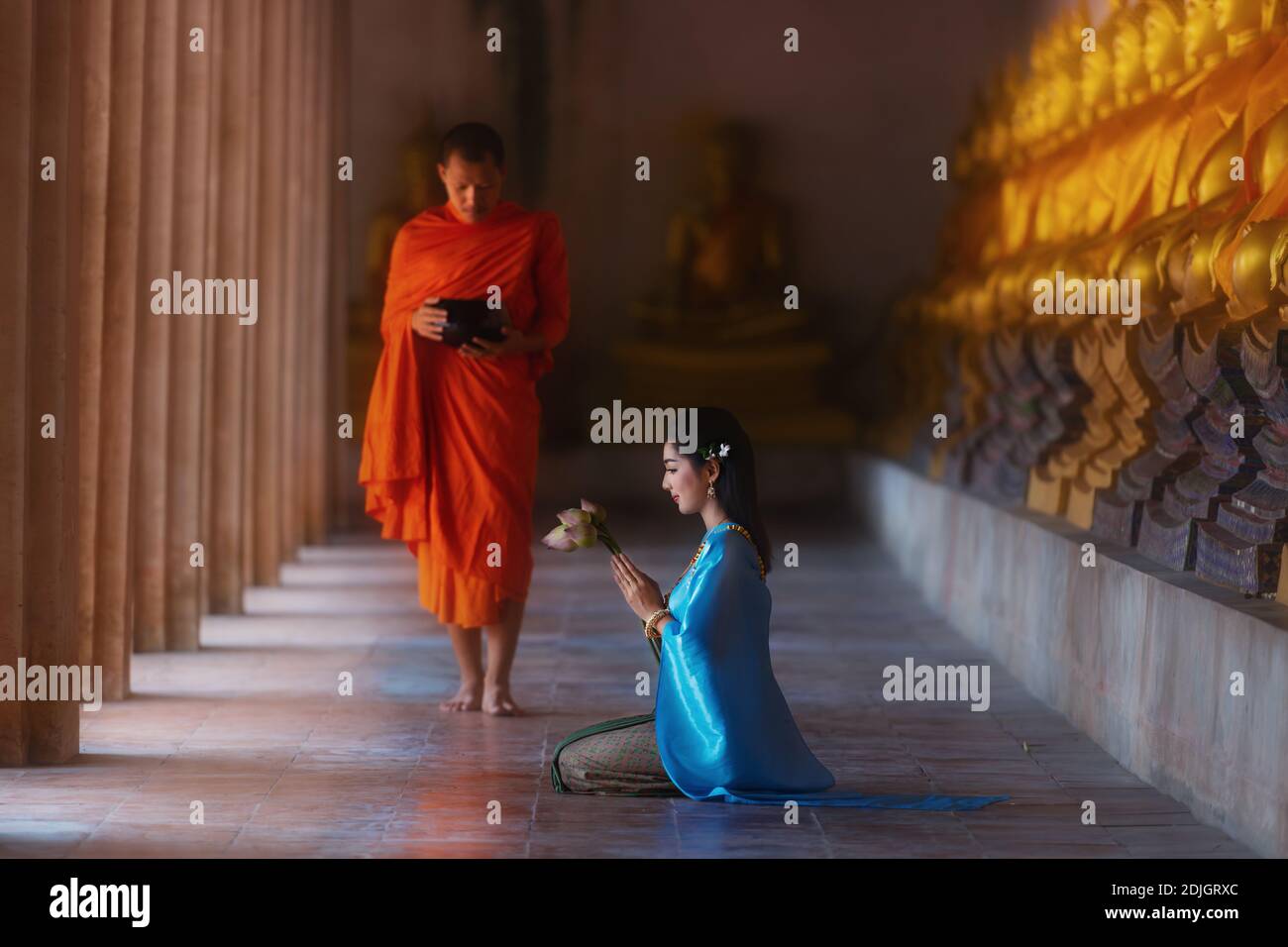 Women giving food to monk hi-res stock photography and images - Alamy