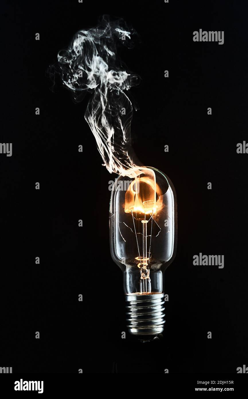 A broken incandescent light bulb is lit Stock Photo - Alamy