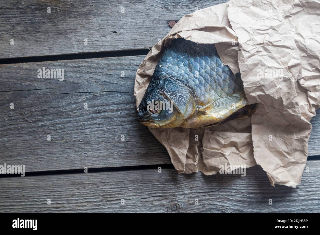 Dried Volga bream vobla in a crumpled kraft paper roll, delicious beer ...