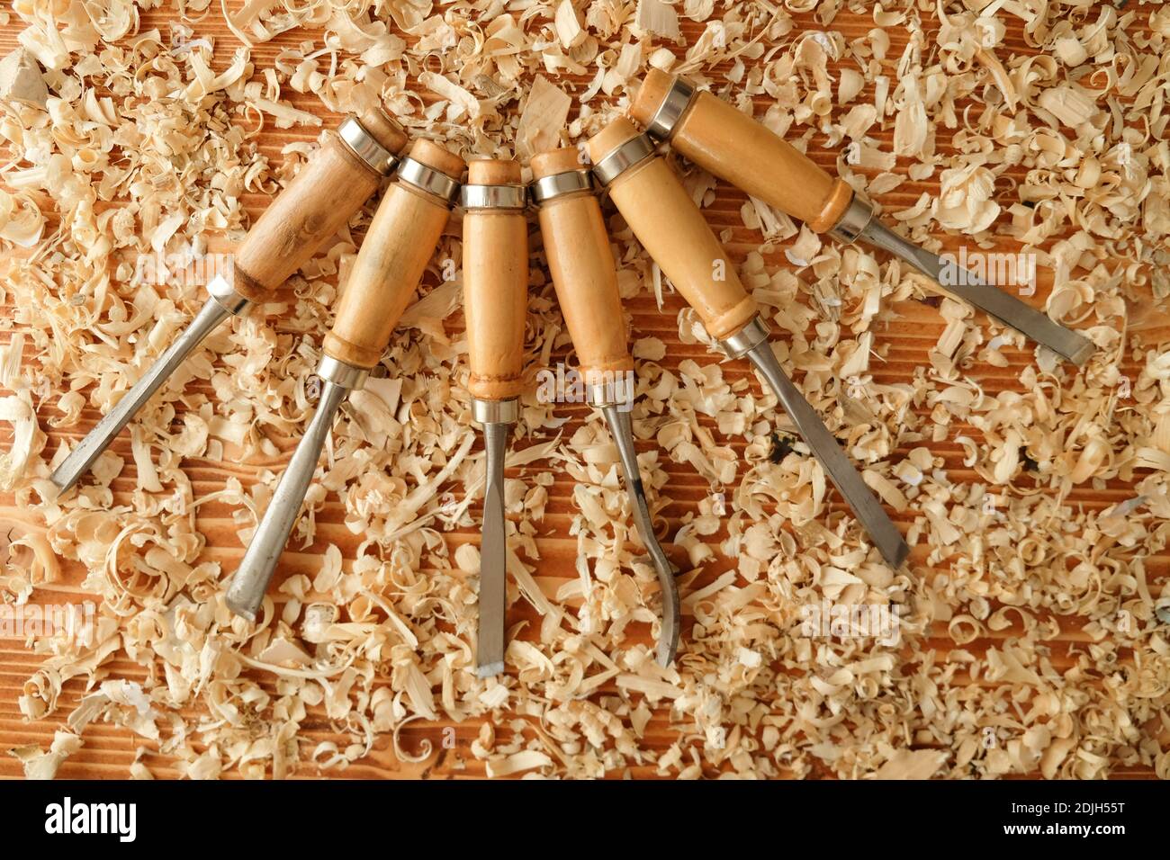 hobby toll chisels on the carpenter's workbench, chisel in the yellow ...