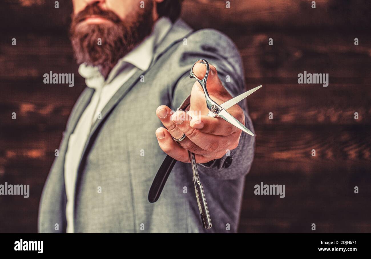 Vintage barbershop. Brutal guy, scissors, straight razor. Bearded ... Vintage barbershop. Brutal guy, scissors, straight razor. Bearded ...
