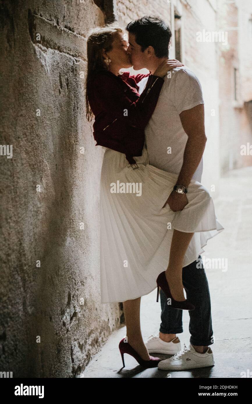 Young Couple Kissing Against Wall High Resolution Stock Photography and Images - Alamy