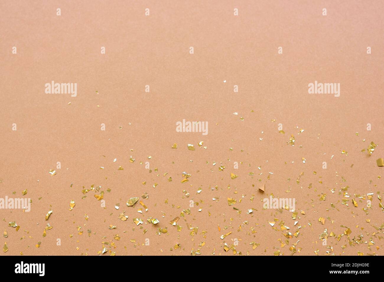 Shiny golden confetti on beige background. Top view, copy space Stock ...