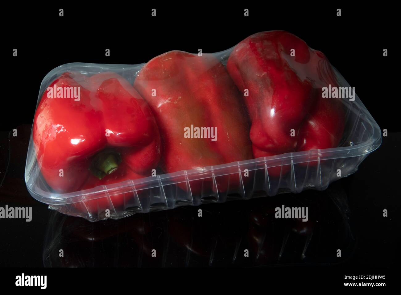 Red sweet pepper wrapped in plastic Stock Photo - Alamy