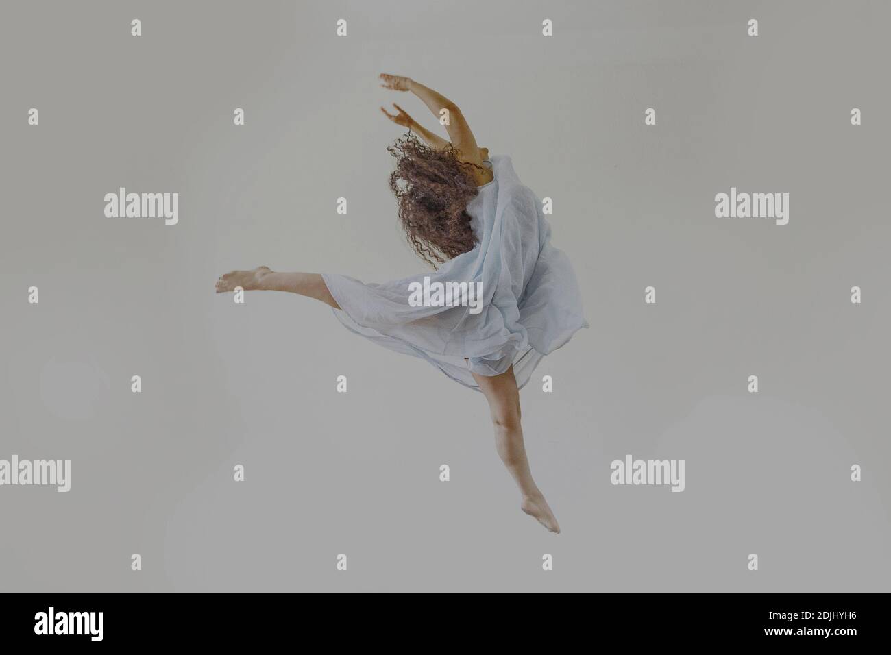 Young Woman Dancing Against White Background Stock Photo - Alamy