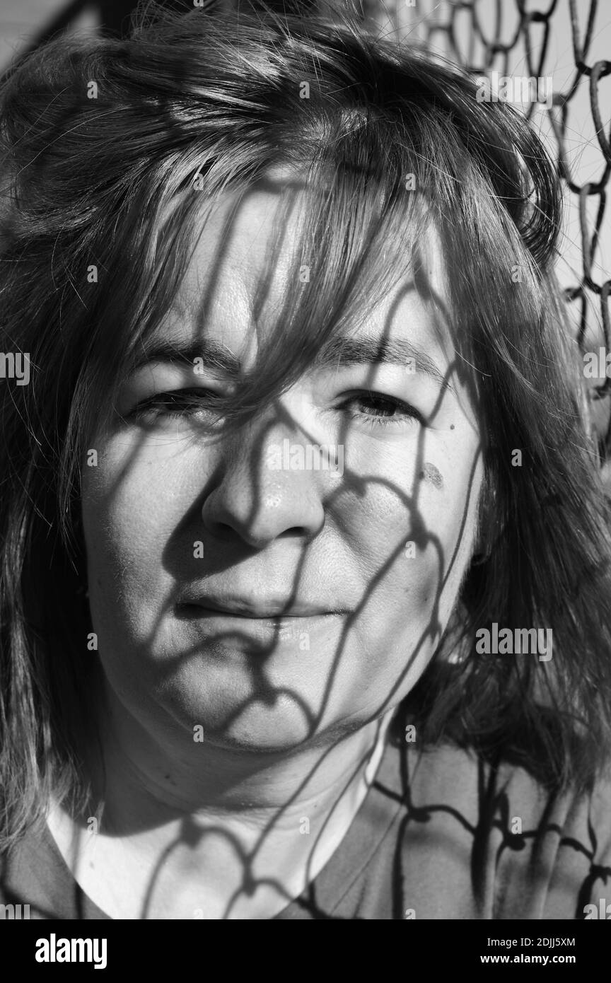 Close-up Portrait Of Mature Woman With Shadow On Face Stock Photo - Alamy