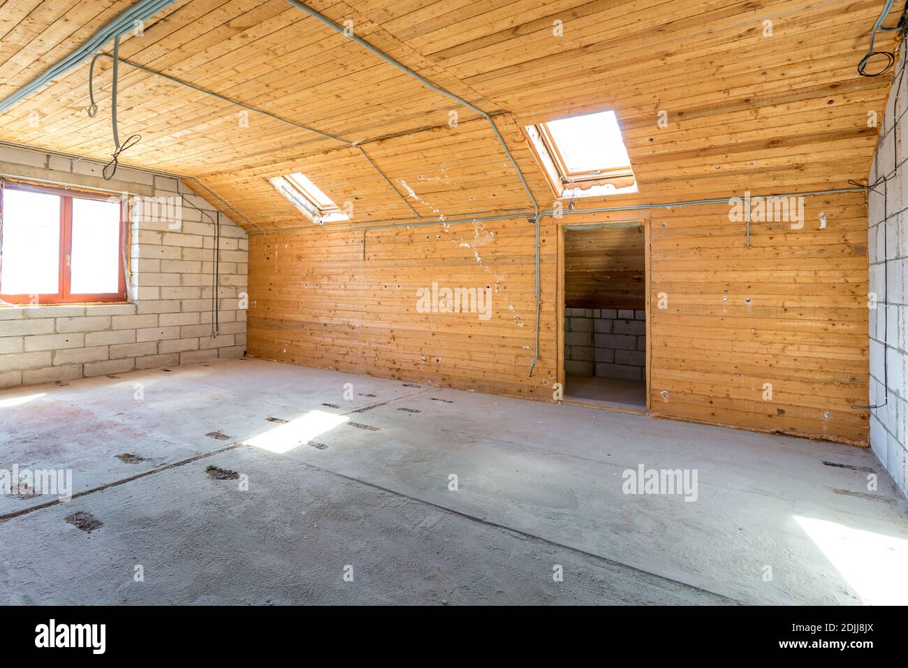 empty interior in house without repair on wooden mansard floor and ...