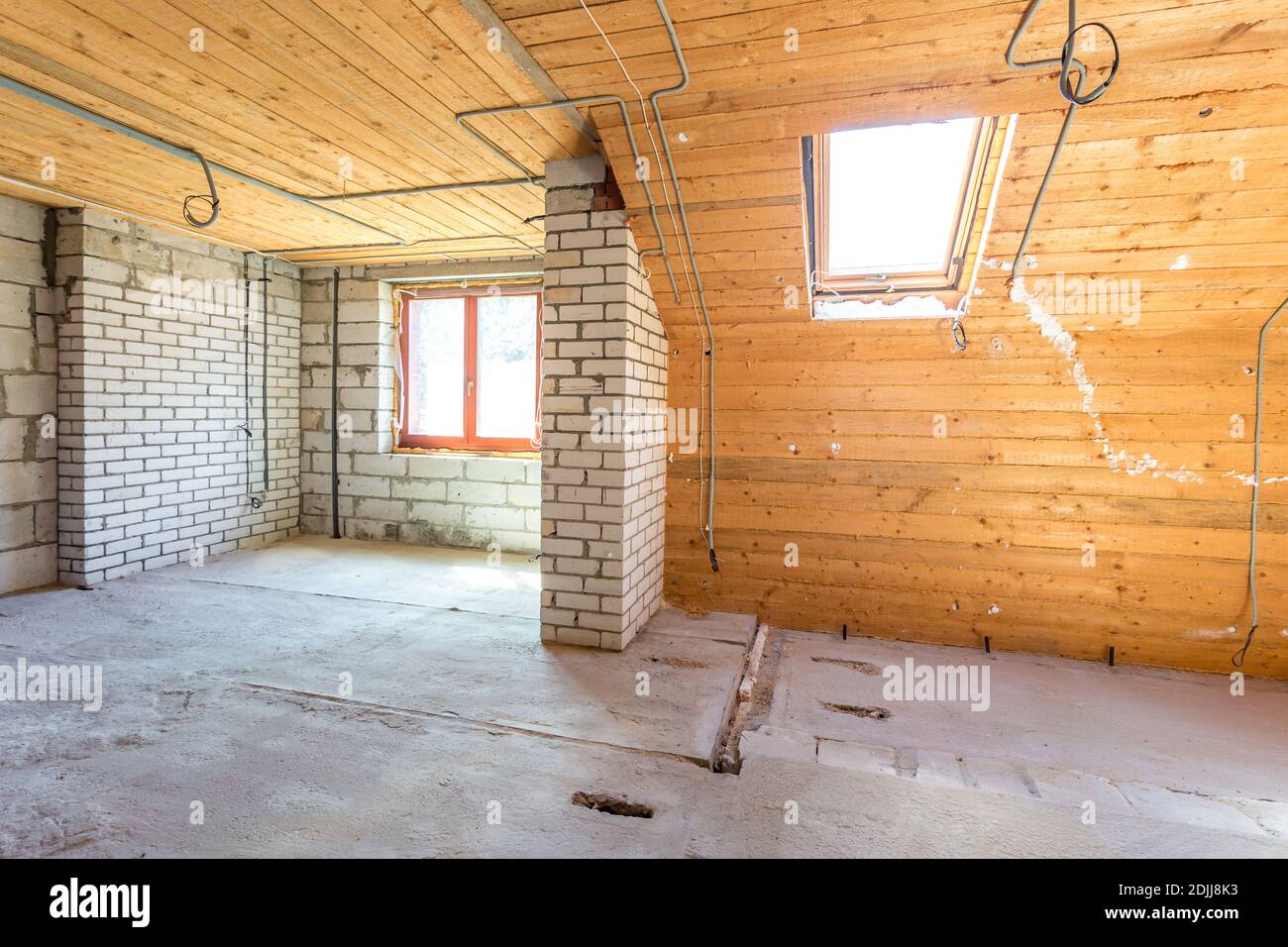empty interior in house without repair on wooden mansard floor and ...