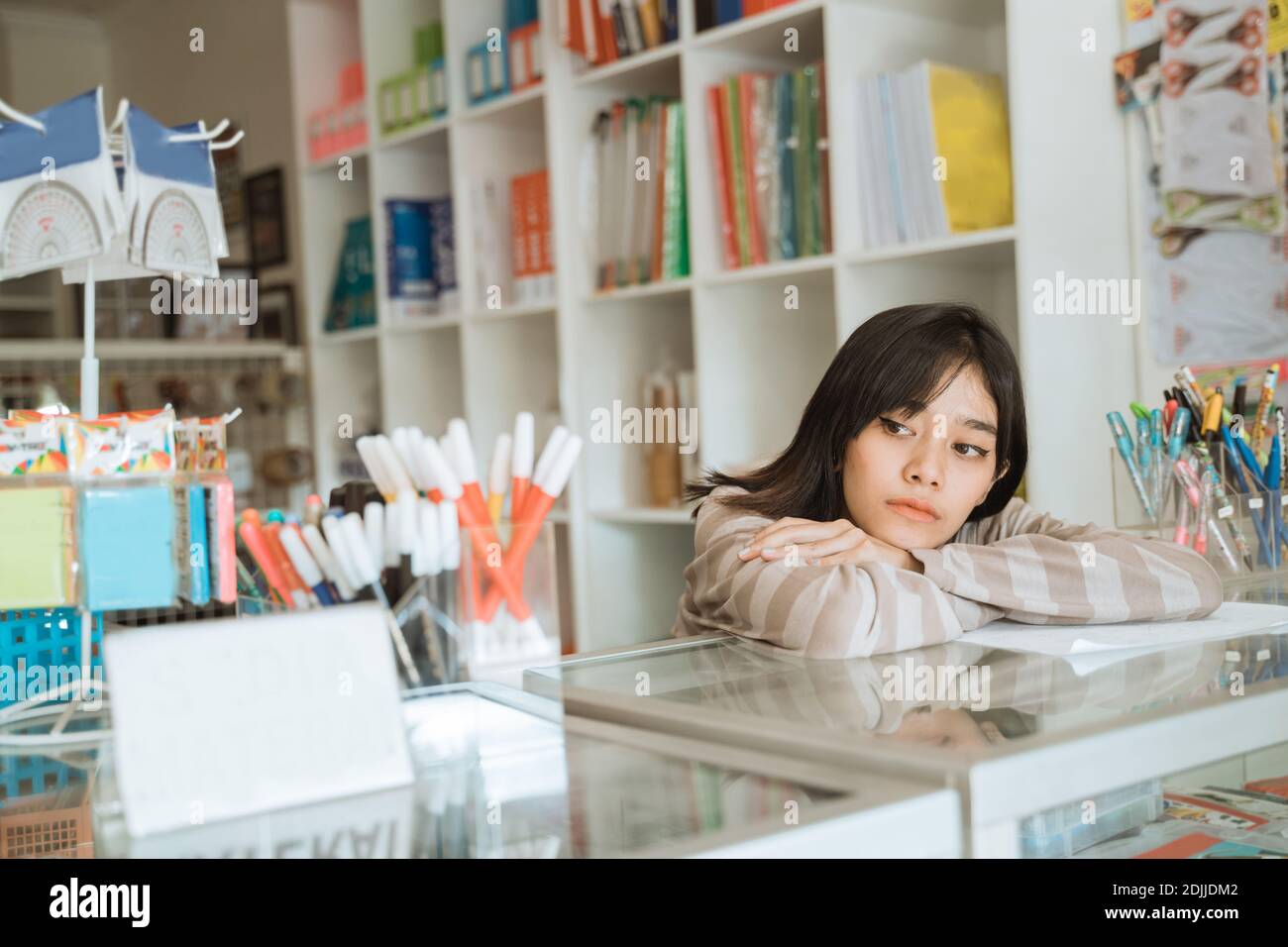 Portrait boring young girl entrepreneur waiting customer working in a ...