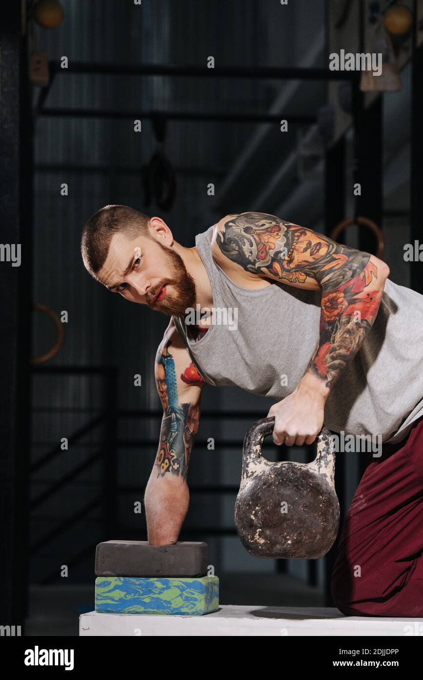 Hard-working armless man doing bent over single arm back row with a ...
