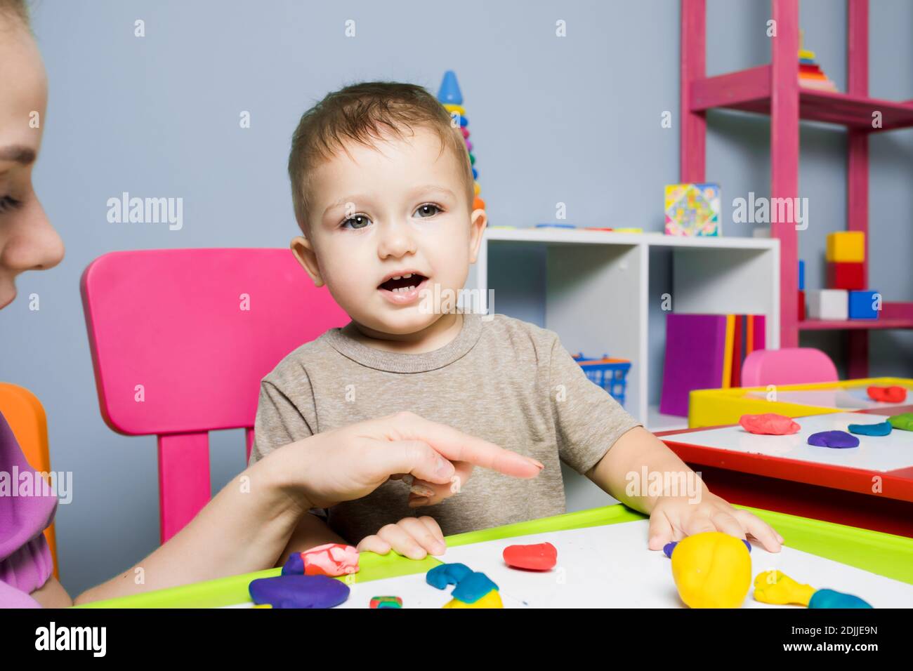 The baby boy learns to create plasticine figures in kindergarten Stock ...