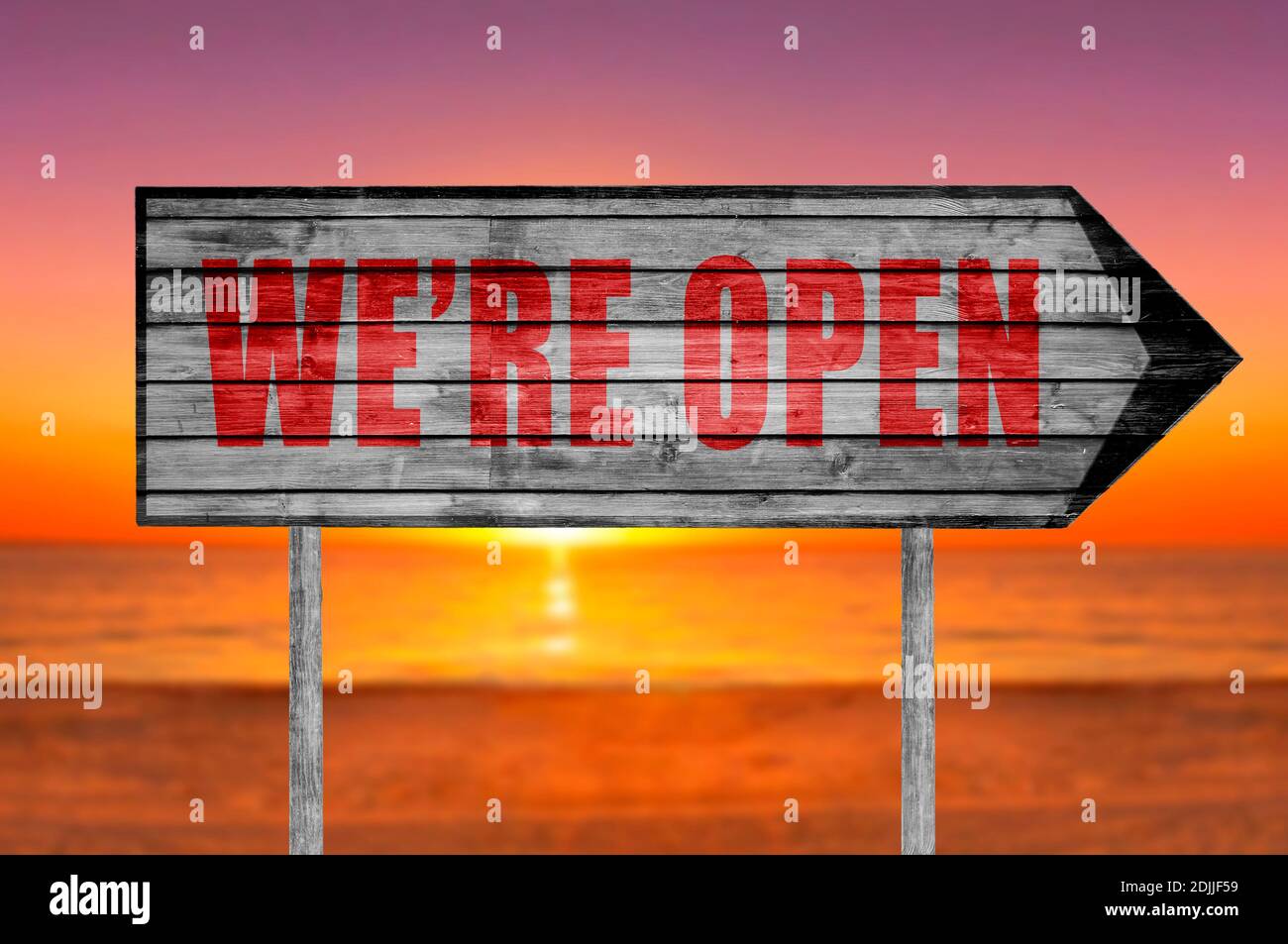 Red We're open wooden sign with on a beach background Stock Photo - Alamy