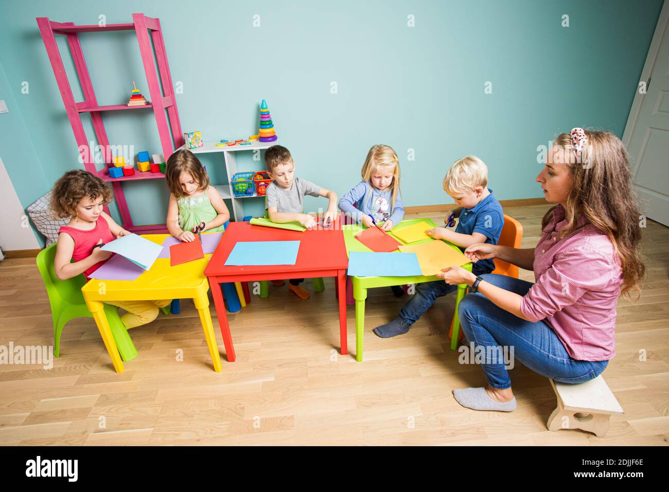 Little kids develop creative abilities with the teacher Stock Photo - Alamy